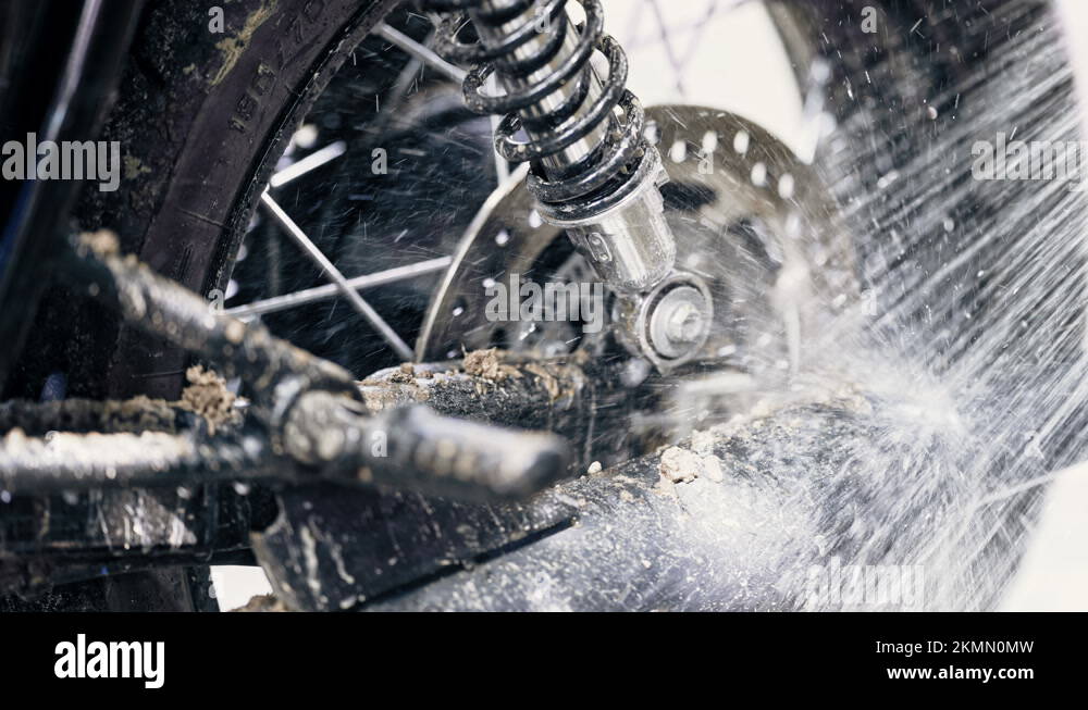 Washing with water rear wheel, exhaust pipe and chain of classic black ...
