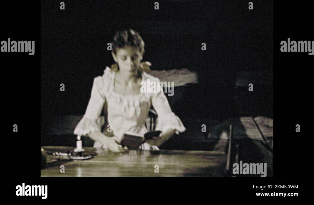 1970s: Title page of book. Young woman sits at table reading book ...