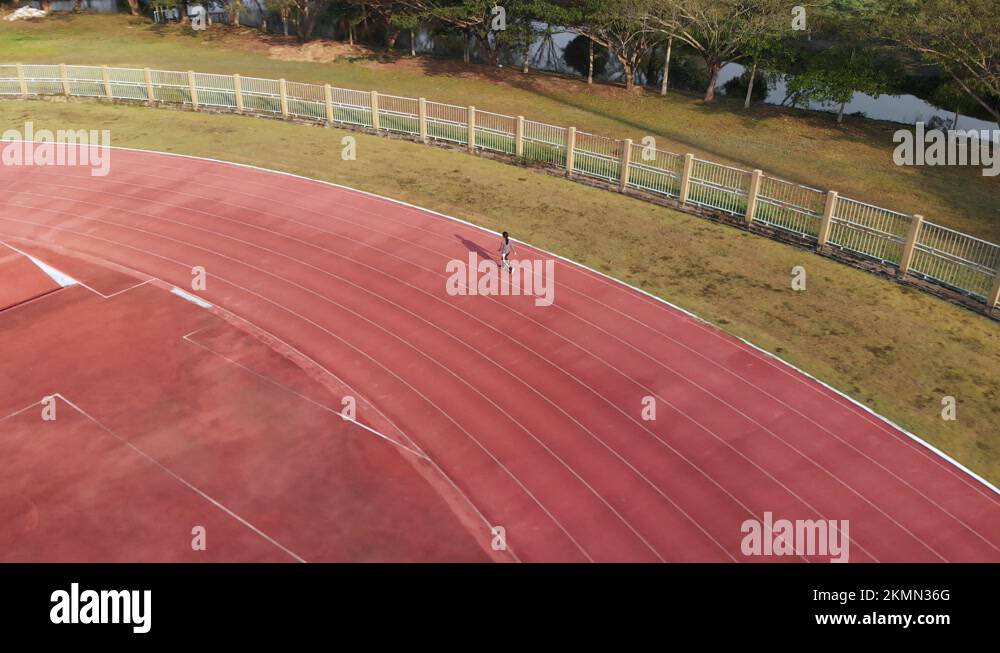 Female Athlete running along track rubber surfaces as basic woman ...