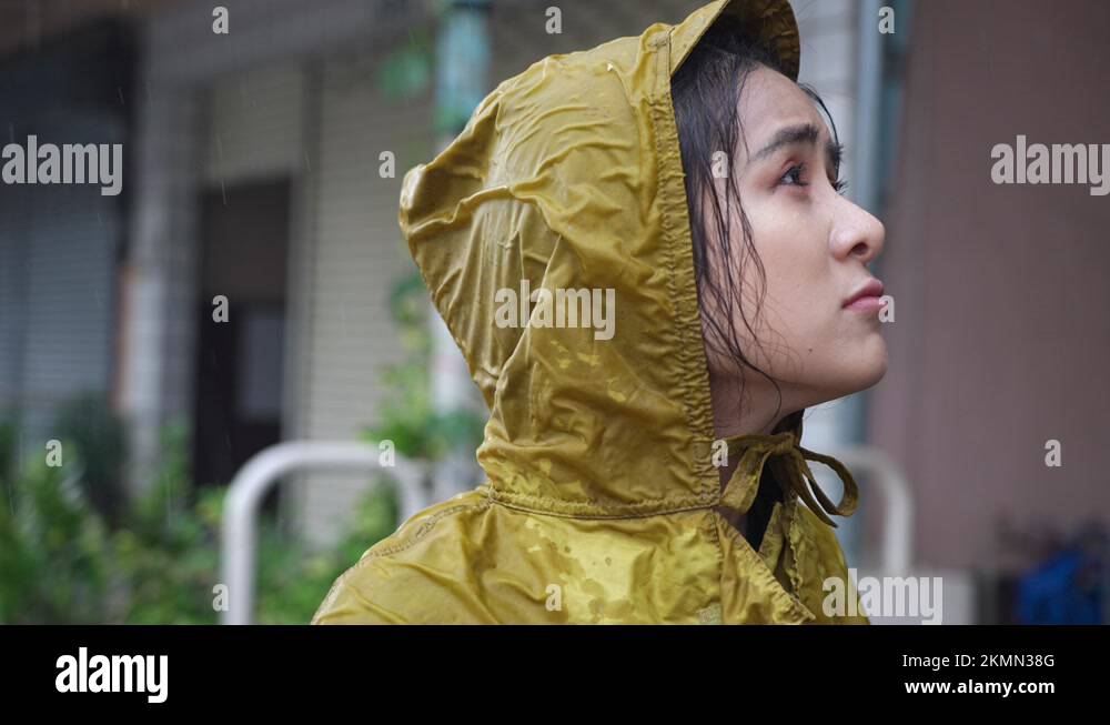 Young asian female disappointed with rains pouring, rainy season ...