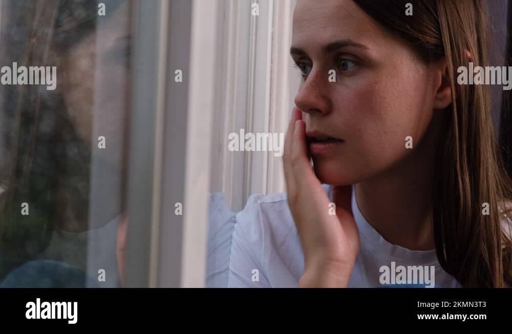 Shocked young woman witnessed horrific event sitting on windowsill at ...