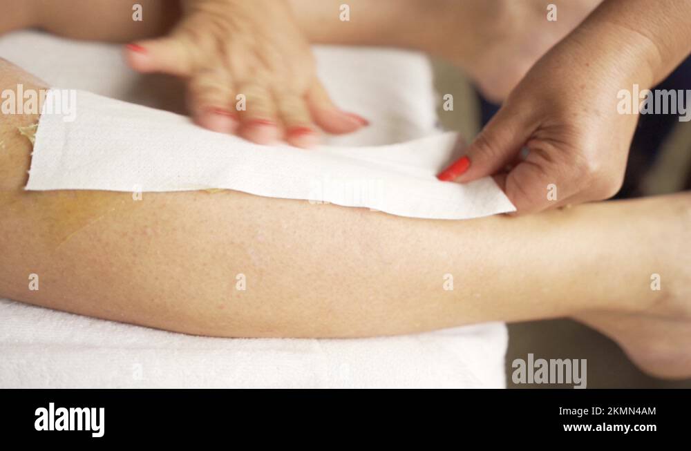 close up female legs hair removal with wax in beauty salon. slow motion ...
