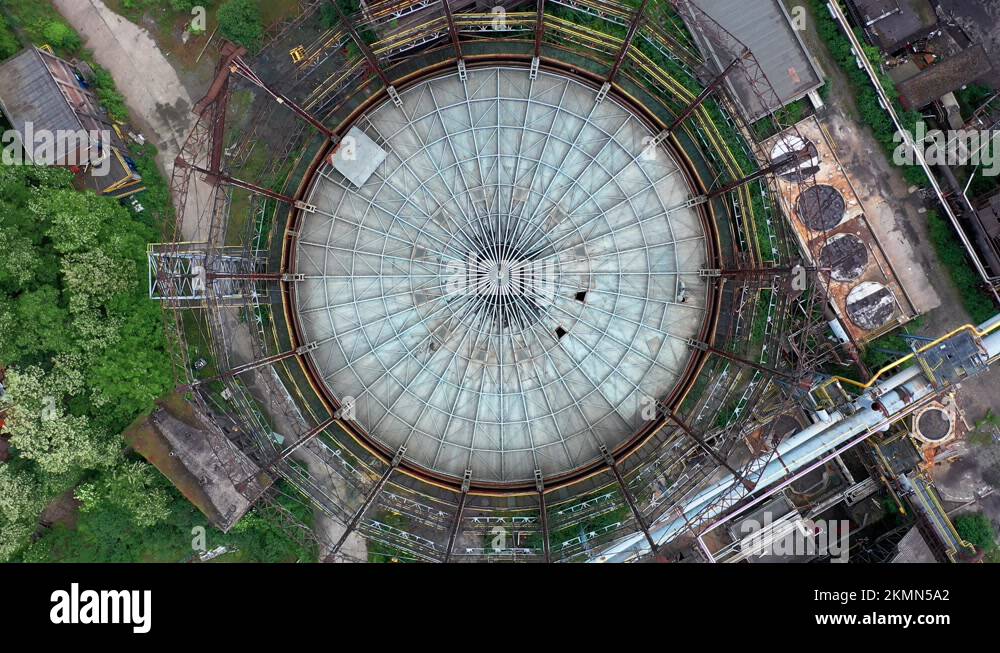 Aerial top-down view of storage tank at abandoned steel factory ...