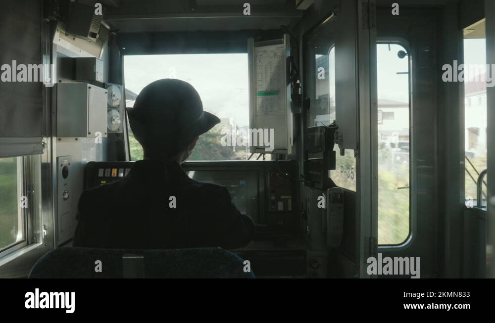 Female Train Conductor At The Driver's Compartment Driving A Train On ...