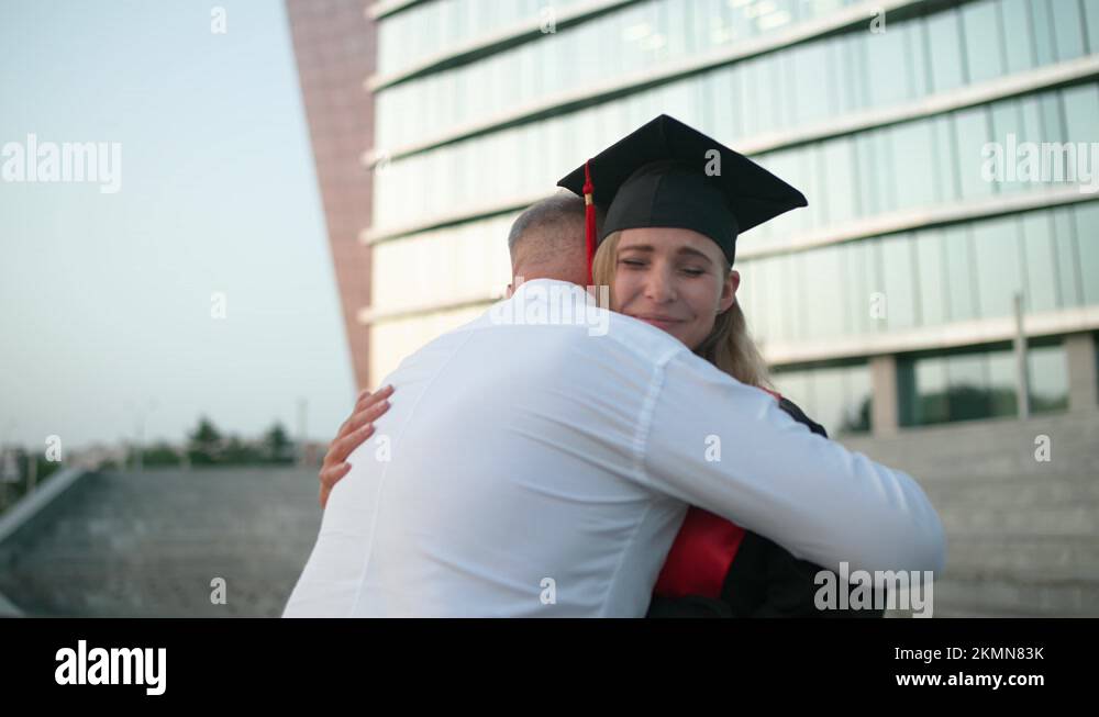 Graduation, a father embraces his daughter, a university graduate ...
