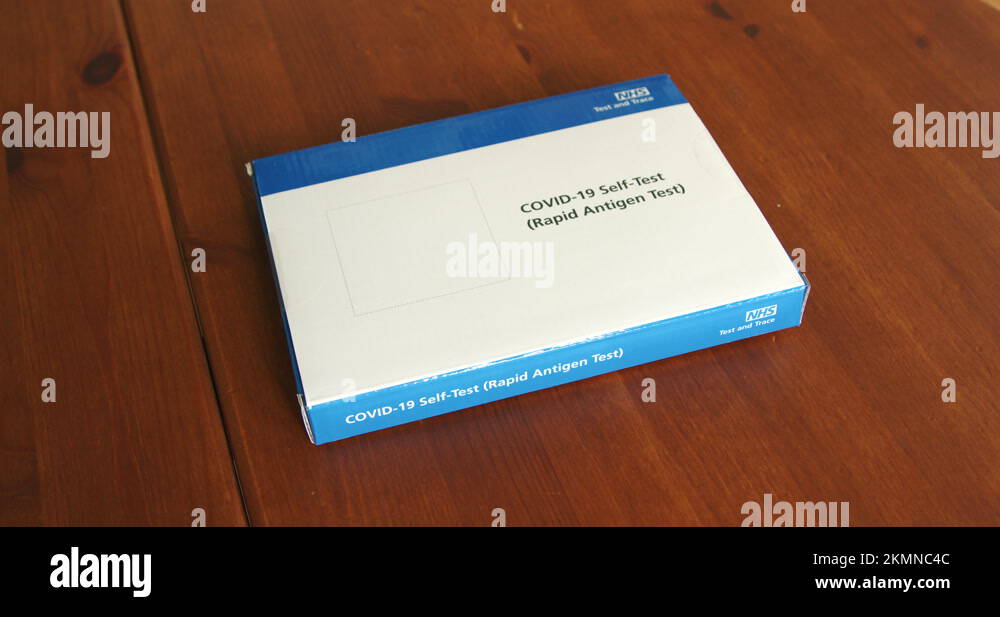 A hand placing the Covid-19 Self-Test (Rapid Antigen Test) pack Stock ...