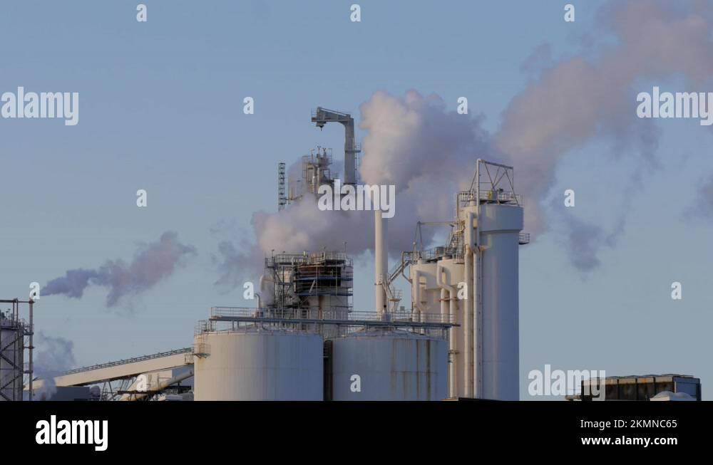 The factory is releasing exhaust gas, the billowing smoke, air ...