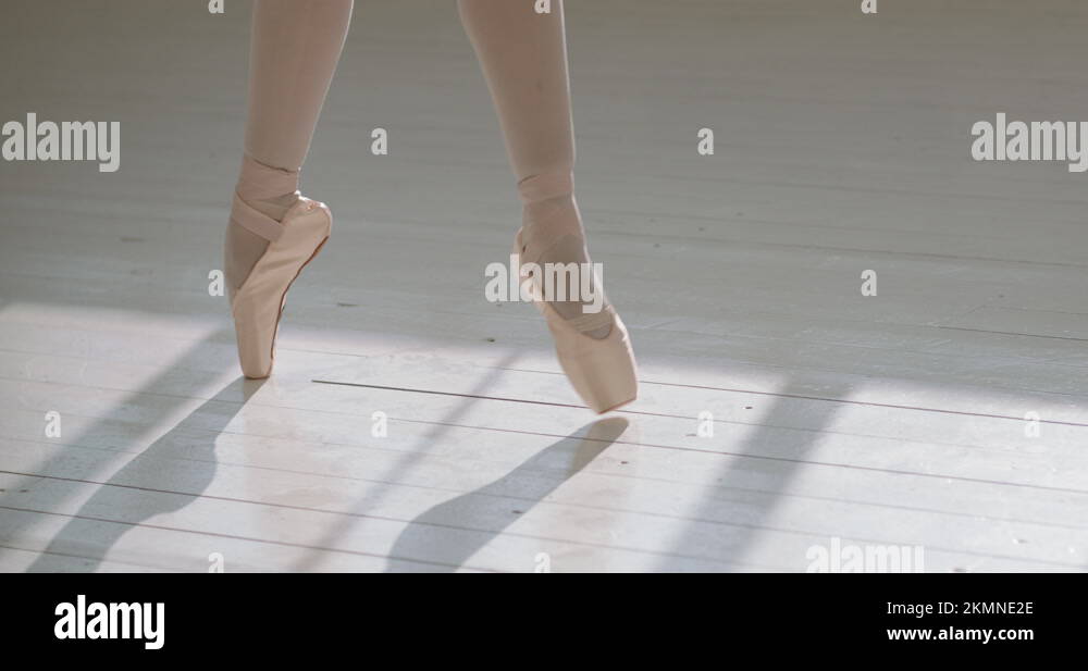 Ballerina standing on tip-toes. Ballet dancer wearing pointe shoes ...