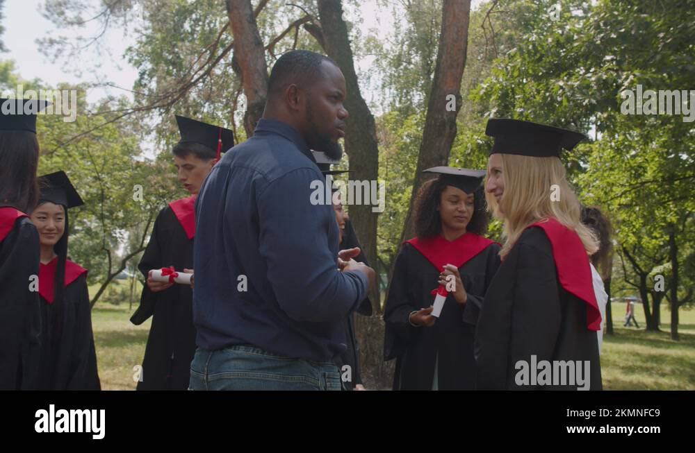 Graduates after graduation ceremony university Stock Videos & Footage ...