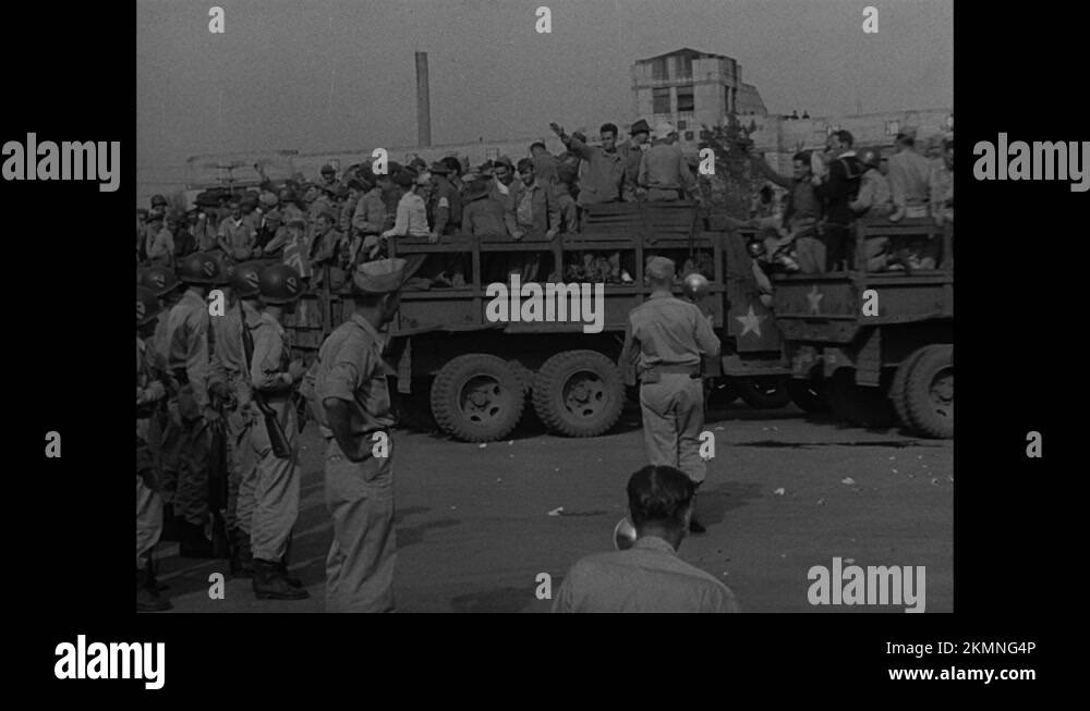1940s: Soldiers load onto troop trucks. Soldiers hold a flag. Soldiers ...