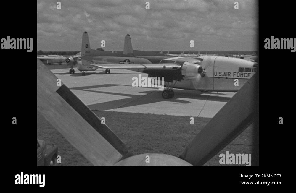 1940s: Air Force cargo planes on tarmac. Soldiers parachute from planes ...