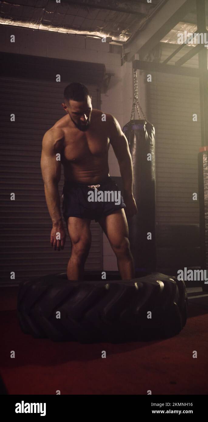A Vertical Video Of A Hispanic Bodybuilder Doing A Tyre Walk In An MMA ...
