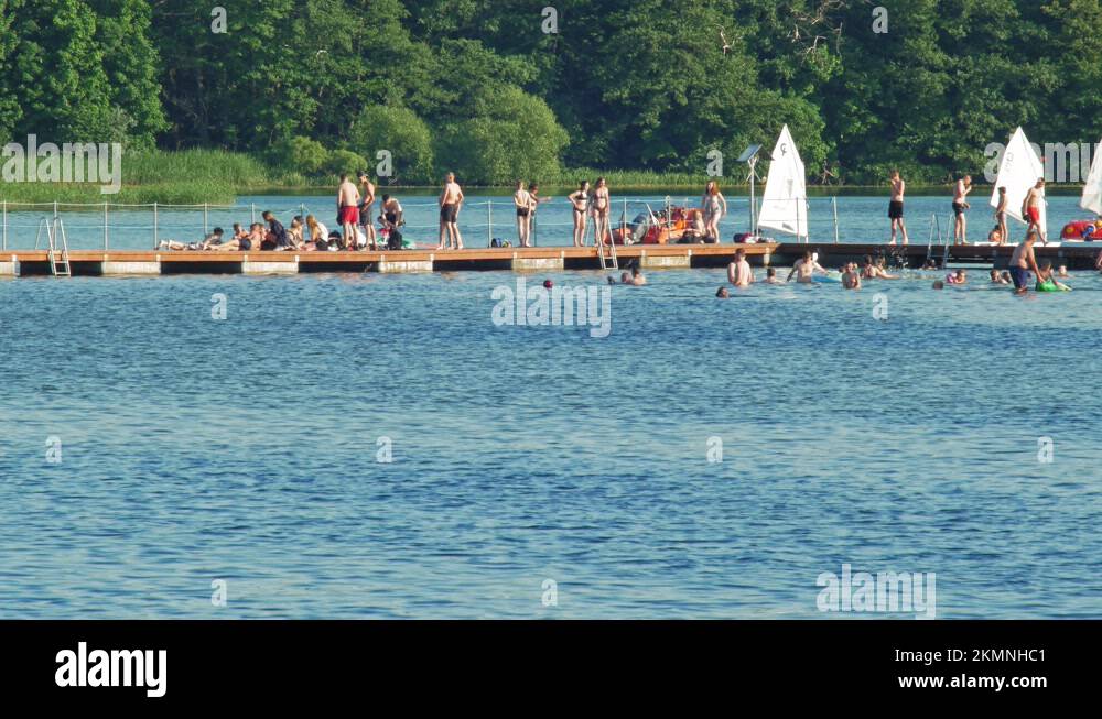 Crowd Of People Having Fun In The Swimming Lake With Jetty In The ...