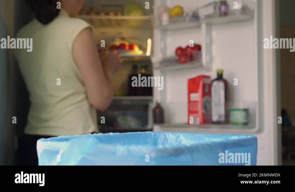 Throwing food waste in the trash. Household food loss. Food spoilage at ...