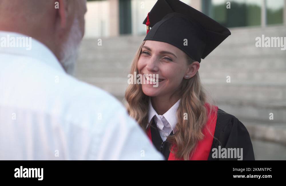 Graduation, a father embraces his daughter, a university graduate ...