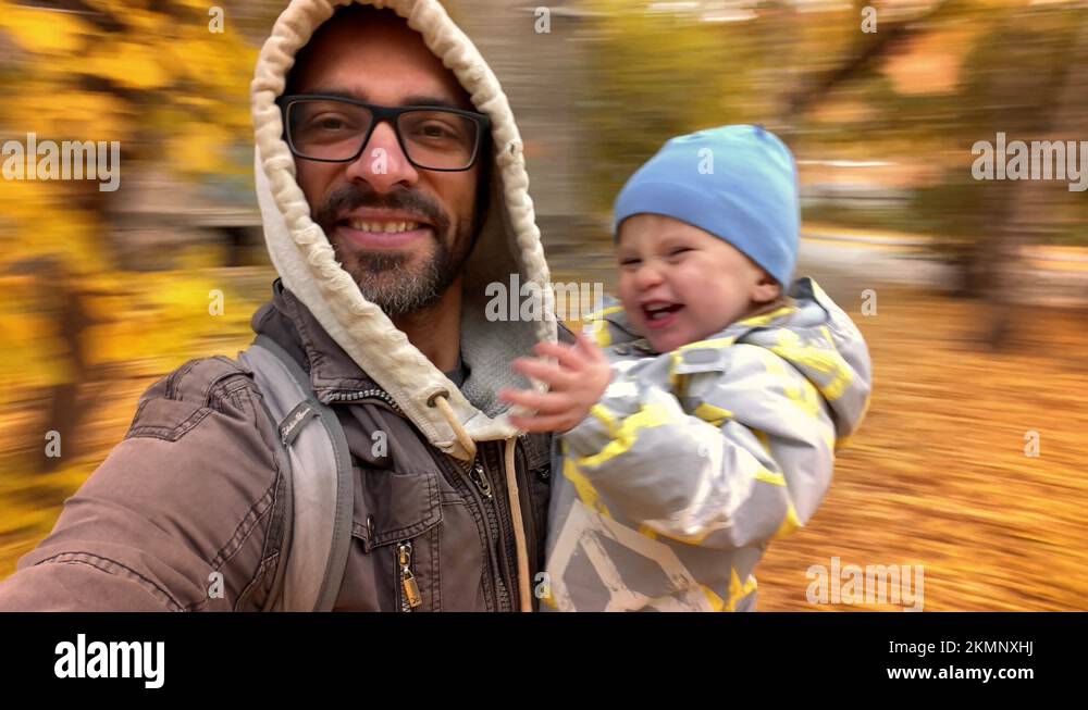 Father and two year old son family spinning child around having fun ...