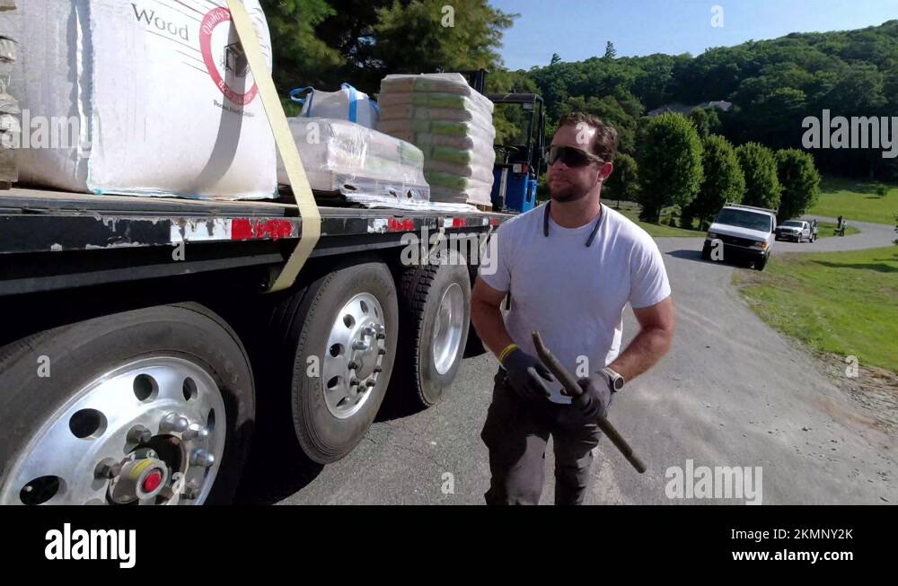 Trucker, Truck driver checks load then hops into cab of semi truck ...