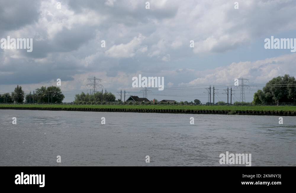 Cargo ships and trains along Amsterdams Rijn Canal waterway in the ...