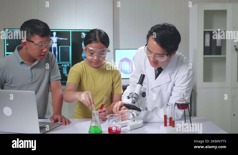 Young Asian Boy And Girl Learning Science Experiment In Laboratory With ...