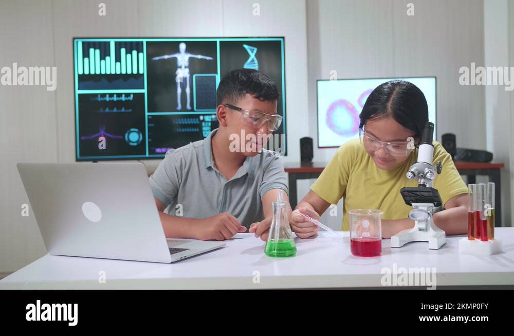 Young Asian Boy And Girl Learning Science Experiment In Laboratory At ...
