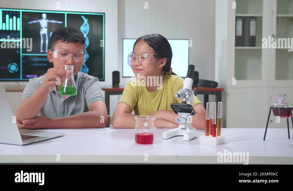 Young Asian Boy And Girl Learning Science Experiment In Laboratory At ...