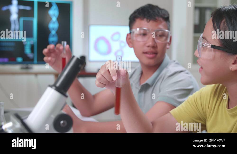 Young Asian Boy And Girl Learning Science Experiment In Laboratory At ...