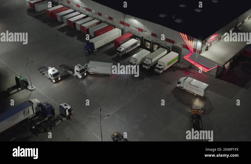 Semi-trailer trucks standing at modern warehouse ramps for loading and ...