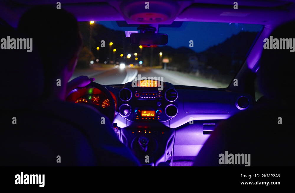 Person in purple light inside the car driving at night 4K Stock Video ...