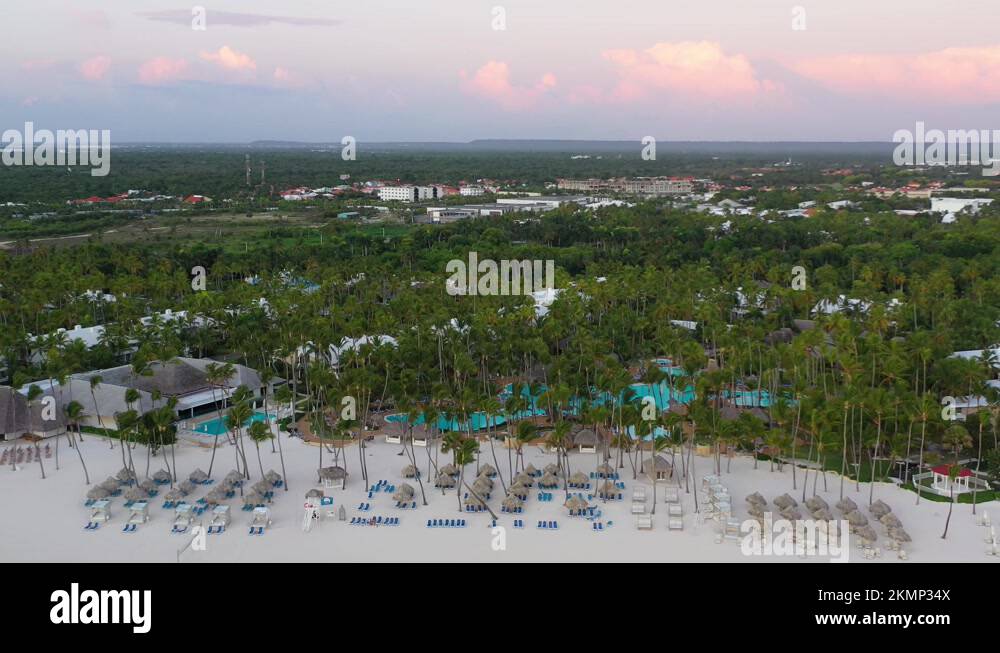 Melia beach resort with palm trees and pool area with bathers during ...