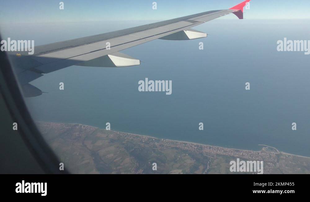 Airplane in the clouds in flight with a view of the wing from the ...