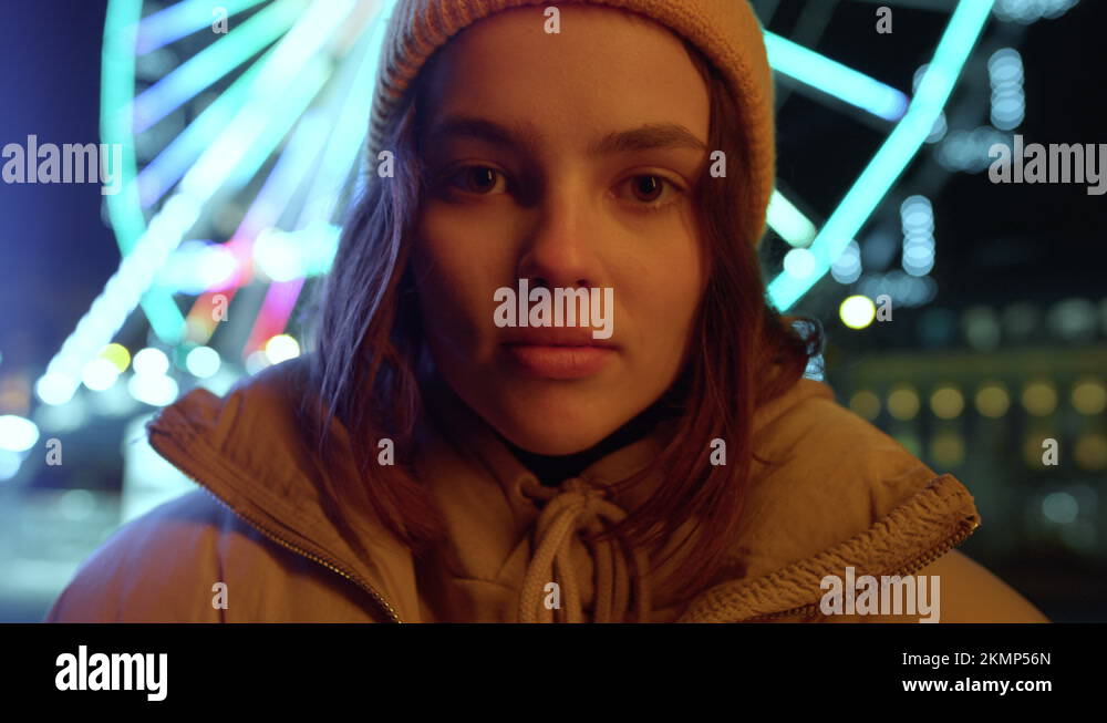 Beautiful woman looking camera on urban street. Girl posing in night ...