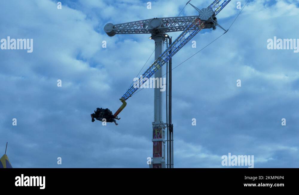 Carnival Ride tall rotating spinning tower with flashing lights and ...