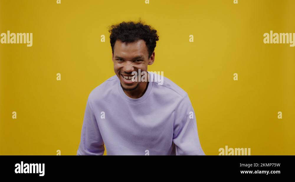 A young mulatto man is very happy, jumping up and down with happiness ...