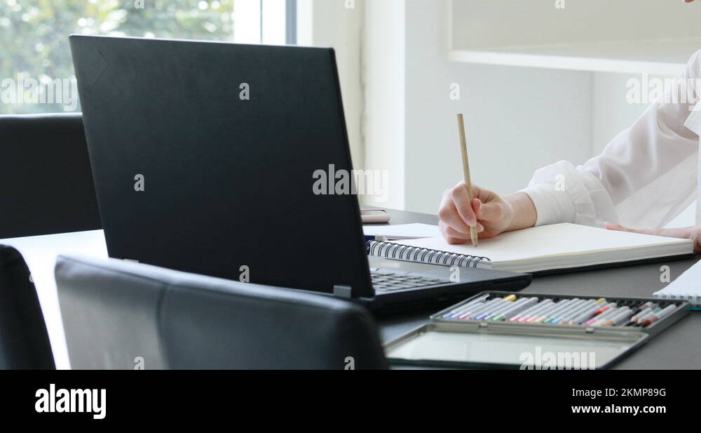 woman in white blouse works or studies drawing with a computer Stock ...