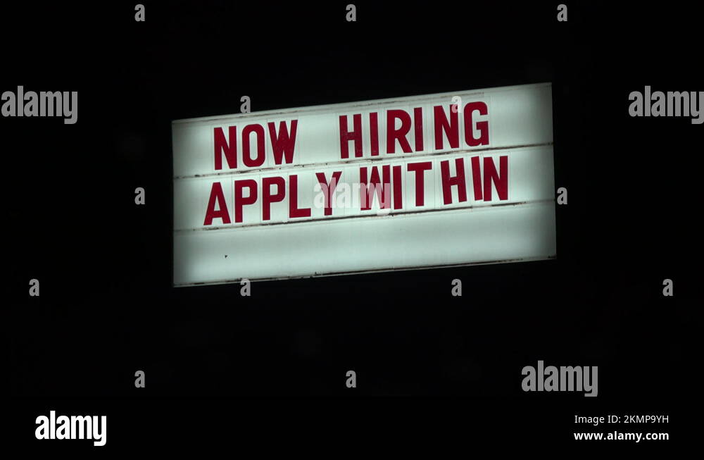 NOW HIRING APPLY WITHIN sign illumintates at night, 4K Stock Video ...