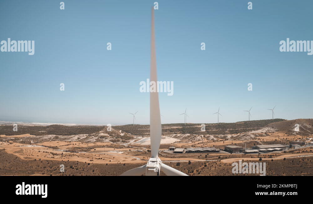 Close-up propeller wind turbine rotates. Panorama wind farm in coastal ...