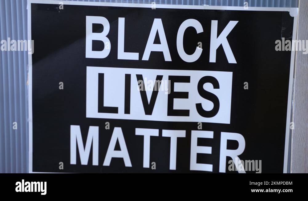 Black Lives Matter BLM sign taped to metal slatted steel wall with ...