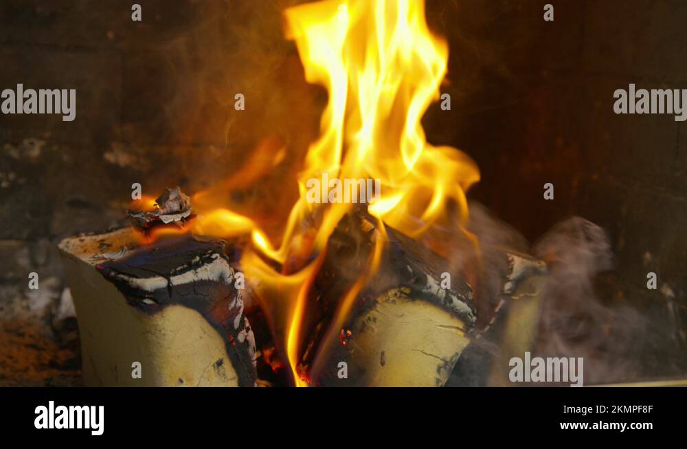 A fire burns in a fireplace close up. Burning chop wood in the stone ...