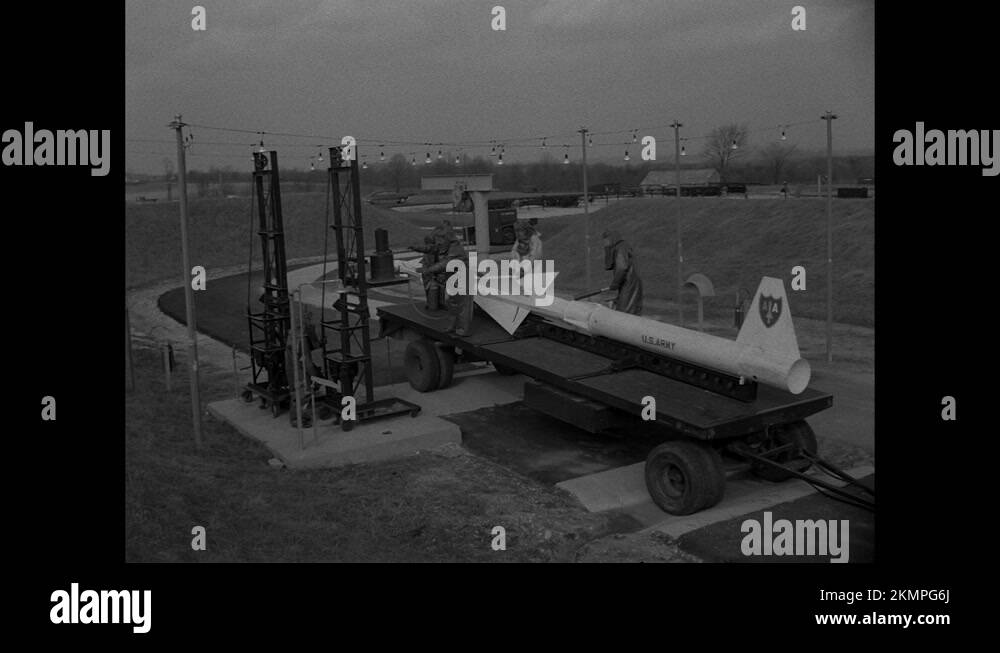 1940s: Officer talks to soldier in window of trailer. Rocket is fueled ...