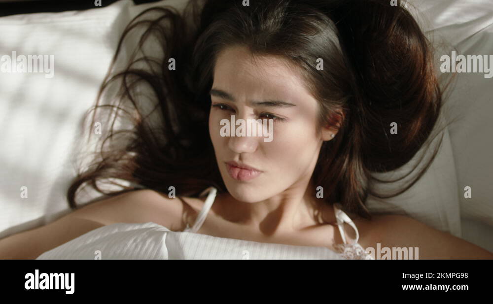 Beautiful asian gen z girl waking up early in morning in cozy ...
