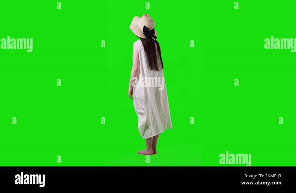 Young asian woman with white dress. Green background for chroma key ...
