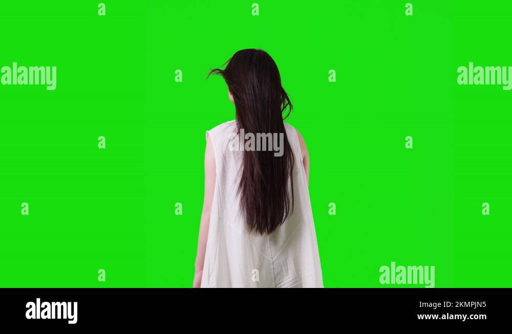 Young asian woman wearing white dress. Green background for chroma key ...