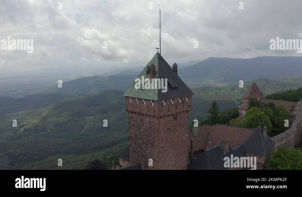 Circulating aerial shot of a tower of a renovated medieval castle in ...