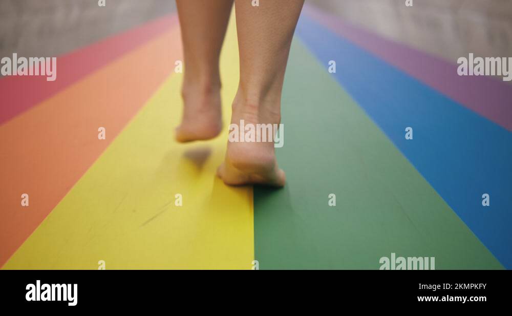 Feet walking barefoot on LGBT rainbow colored crosswalk, Concept of ...