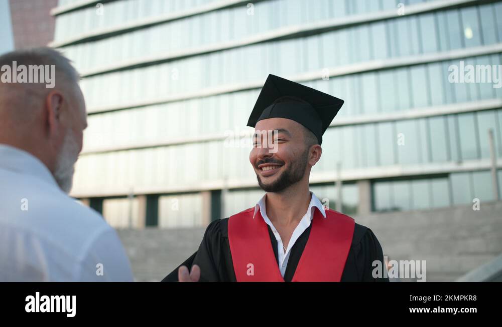 Graduation, a father embraces his son, a university graduate, young man ...