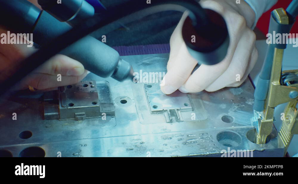 modern technology. male hands hold a soldering iron and solder the wire ...