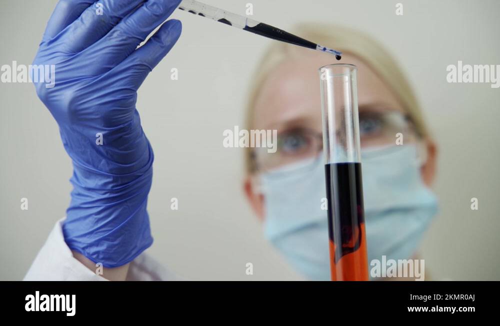Female Laboratory Scientist Conducts Experiment in Science lab looking ...