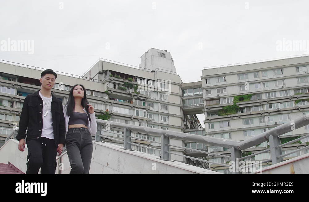 Cool trendy asian couple going down on stair in the city in cloudy day Stock Video Footage - Alamy