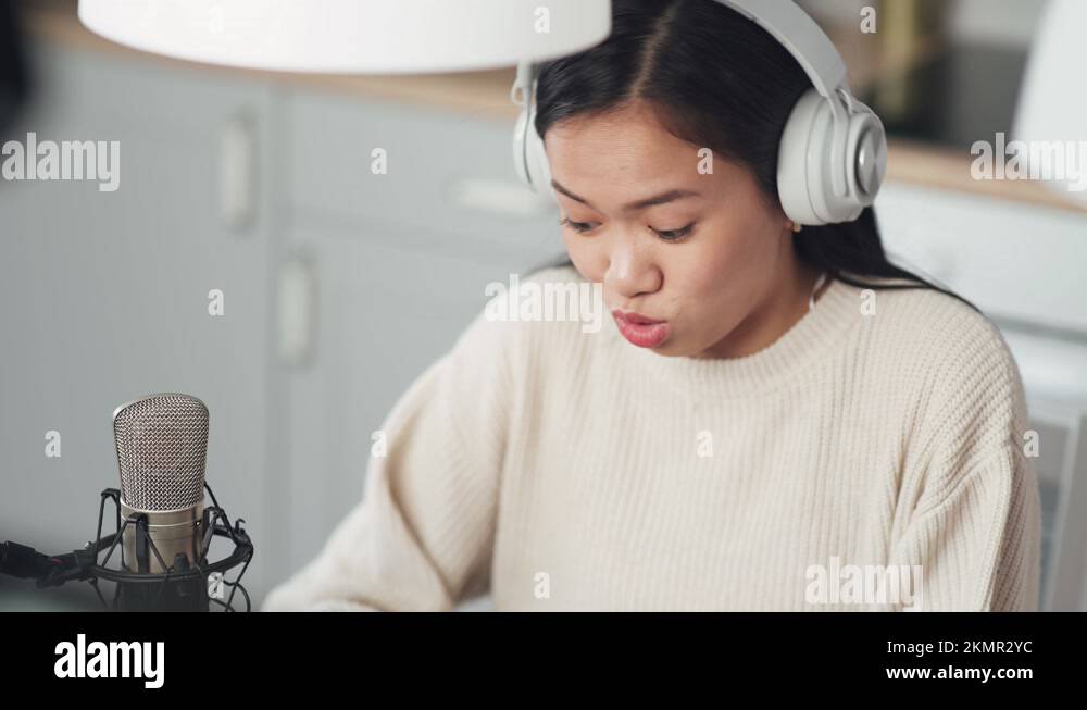 Portrait of a asian female streamer in the headphones, woman makes a ...