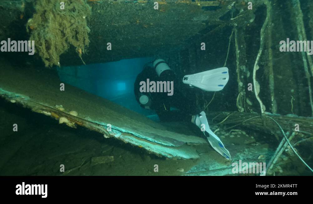 Scuba diver swims inside of the shipwreck Swedish ferry MS Zenobia ...